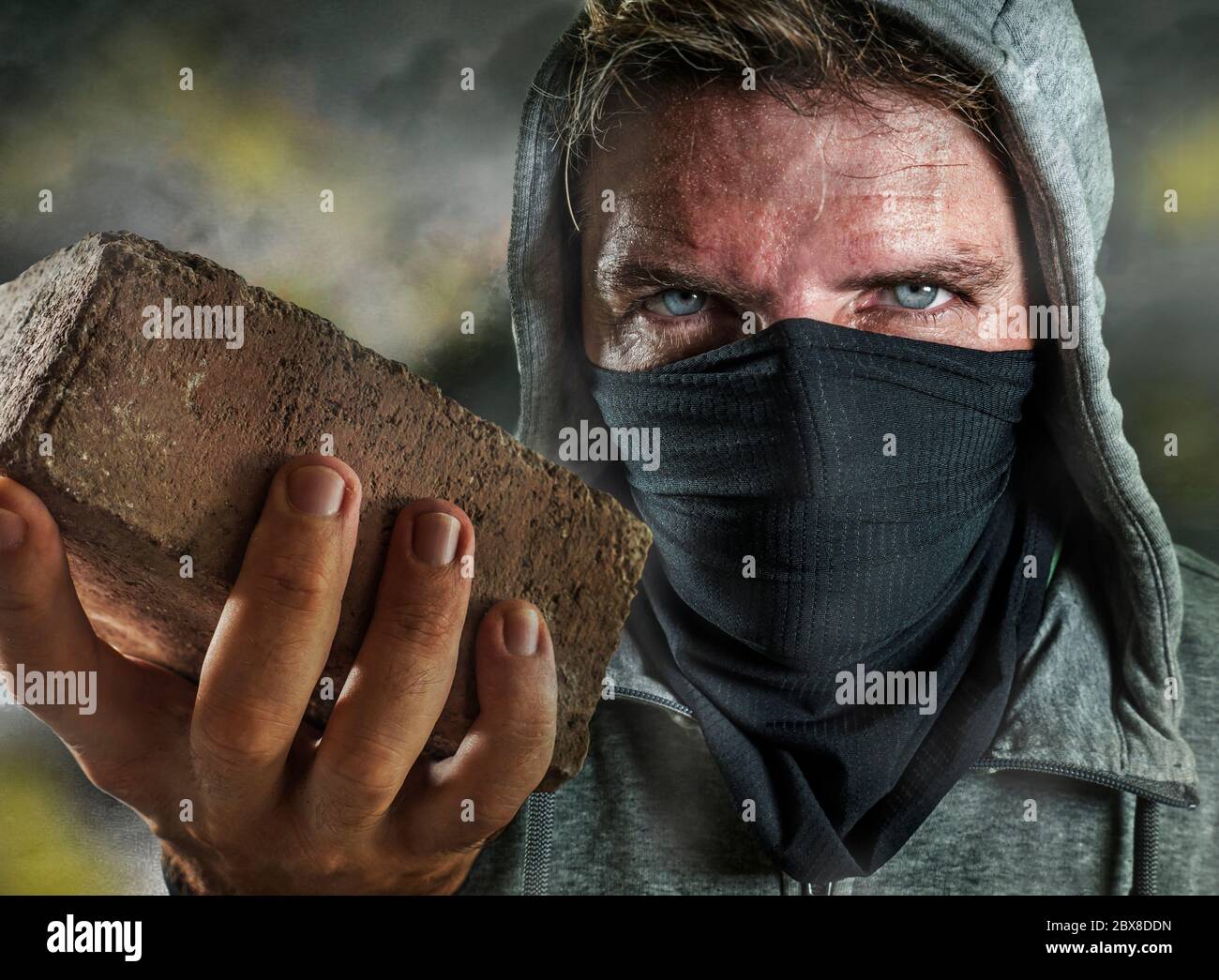 young man as ultra and radical anarchist rioter . furious antifa ...