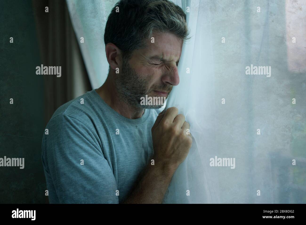 dramatic indoors portrait of mid adult man crying sad and depressed ...