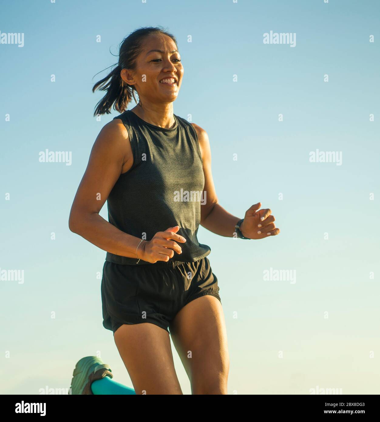 outdoors fitness portrait of young attractive and athletic Asian ...