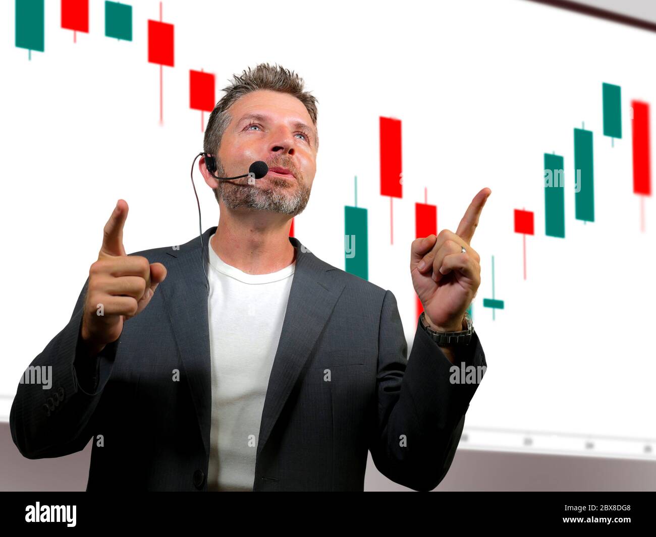 attractive and confident successful trader man with headset speaking at ...