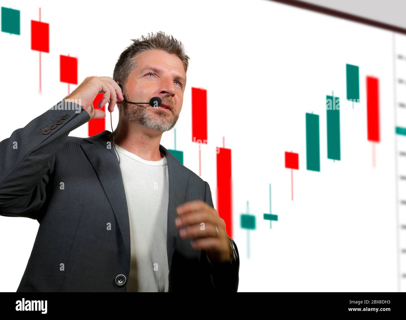 attractive and confident successful trader man with headset speaking at ...
