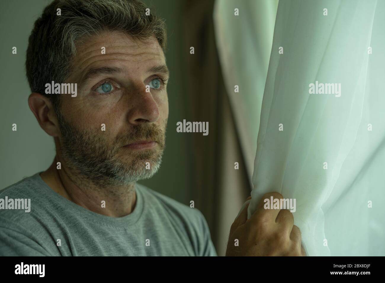 dramatic indoors portrait of mid adult man crying sad and depressed ...