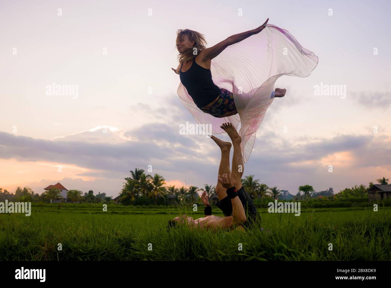 outdoors sunset acroyoga workout - young happy and fit couple ...