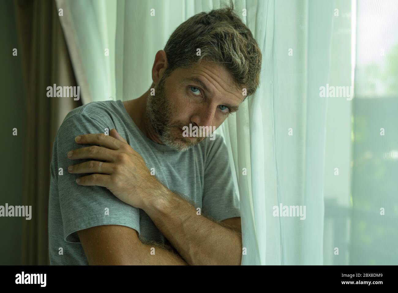 dramatic indoors portrait of mid adult man crying sad and depressed on ...