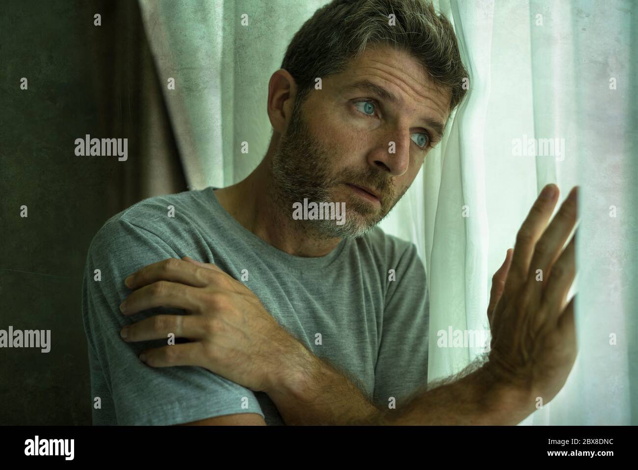 dramatic indoors portrait of mid adult man crying sad and depressed on ...