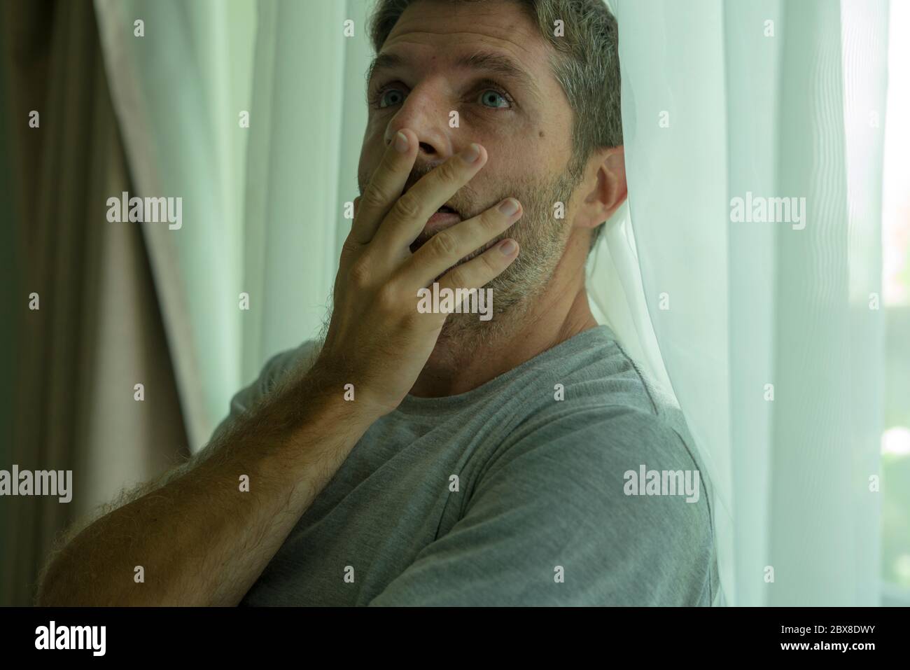 dramatic indoors portrait of mid adult man crying sad and depressed on ...