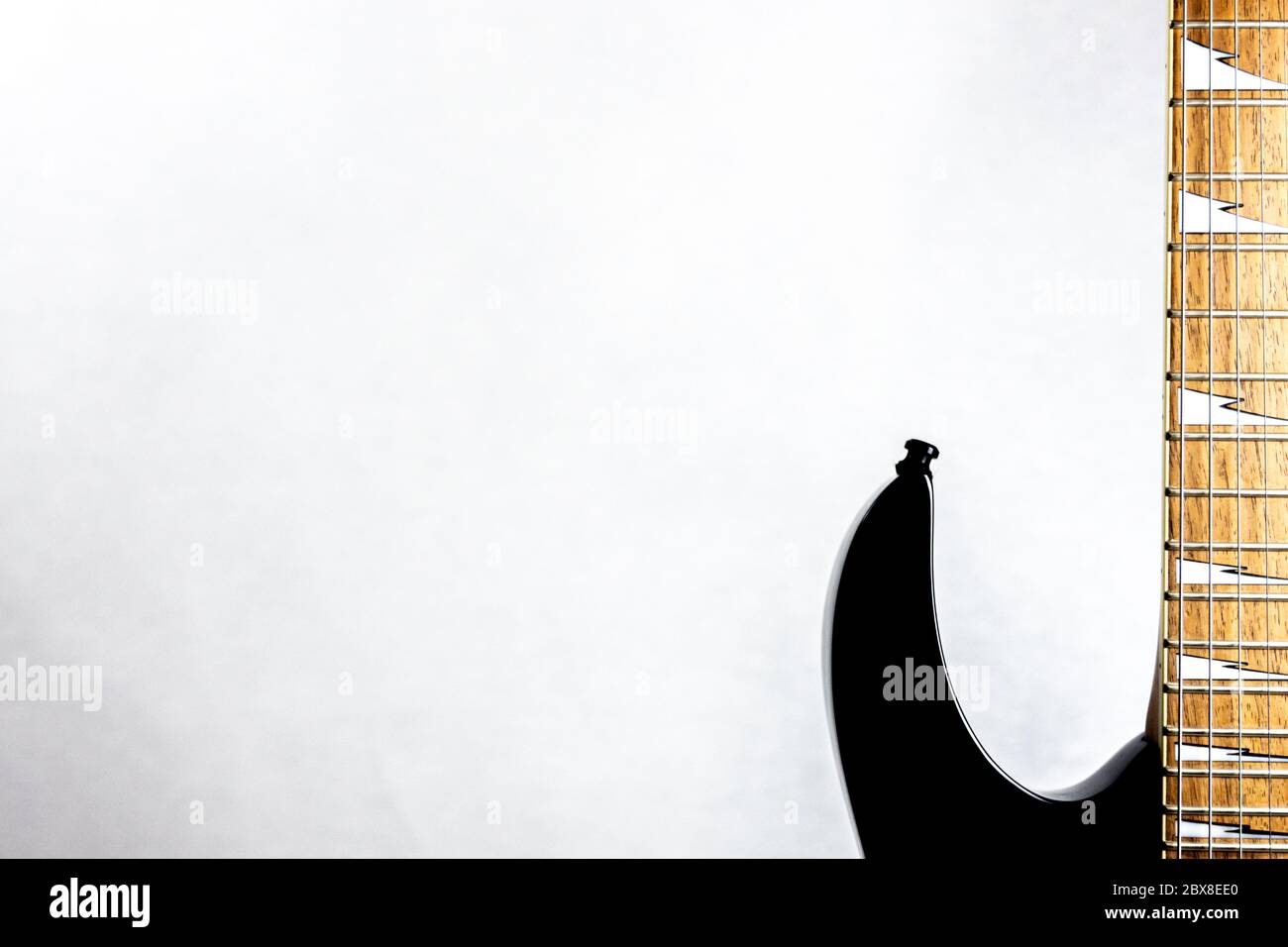 Electric guitar placed on the right side in landscape format on a light ...