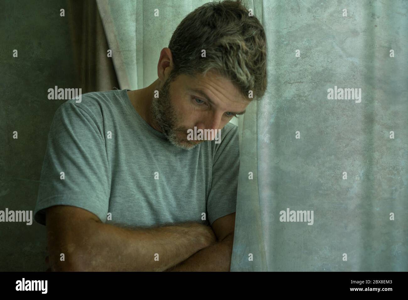 dramatic indoors portrait of mid adult man crying sad and depressed ...