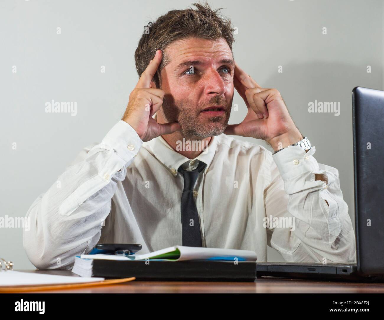 corporate business work stress - young desperate and frustrated ...