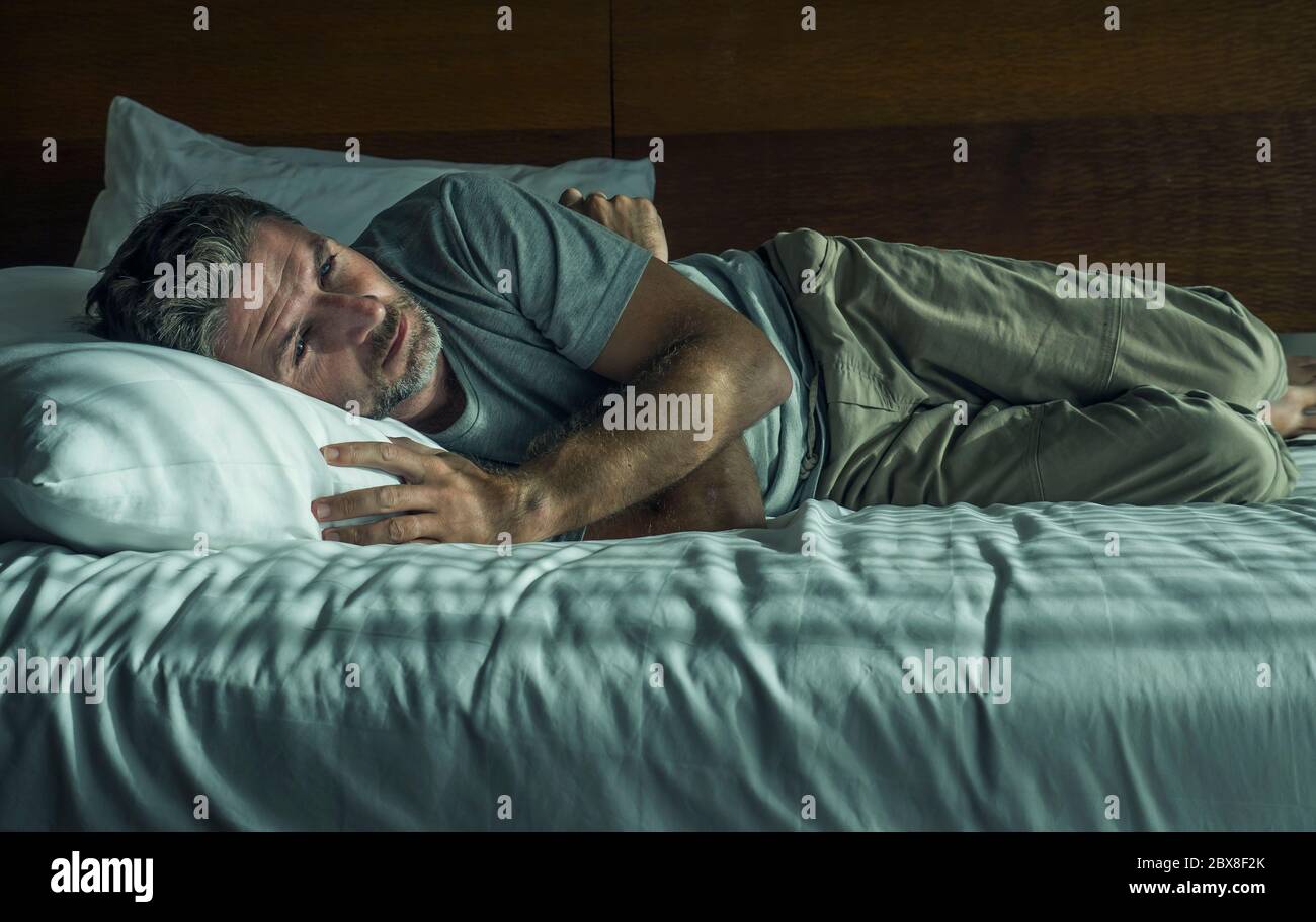 dramatic lifestyle portrait of young attractive sad and depressed man ...