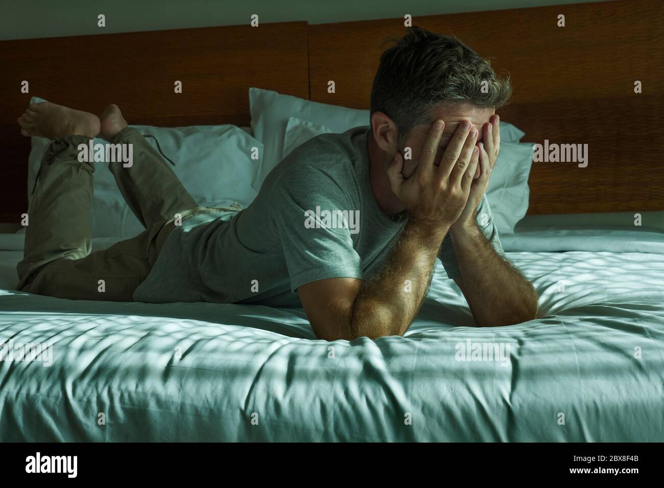 dramatic lifestyle portrait of young attractive sad and depressed man ...