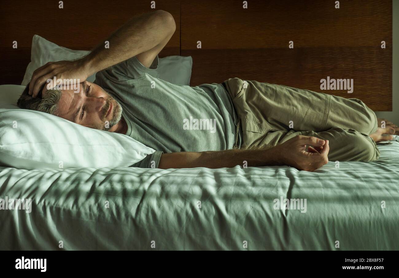 dramatic lifestyle portrait of young attractive sad and depressed man ...