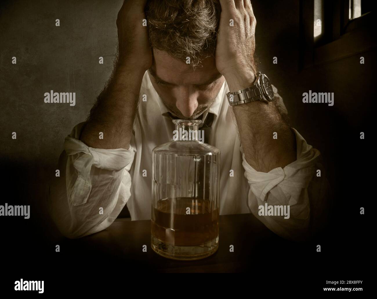 dramatic portrait of 30s to 40s drunk man in lose necktie drinking ...