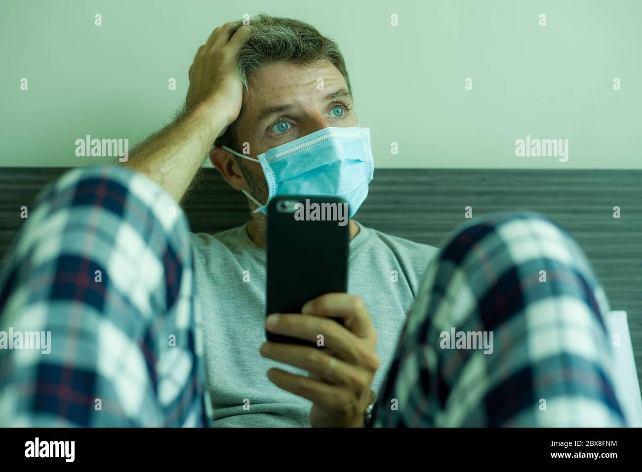 virus outbreak - dramatic portrait of sick man in medical facial mask ...
