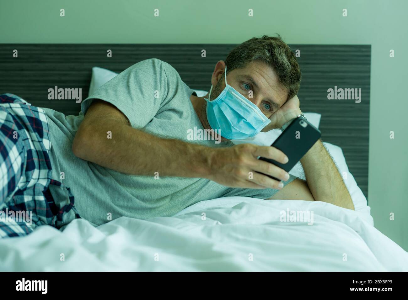 virus outbreak - dramatic portrait of sick man in medical facial mask ...