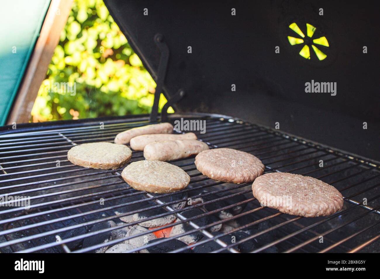 Summer time outdoor BBQ cooking meat Stock Photo - Alamy