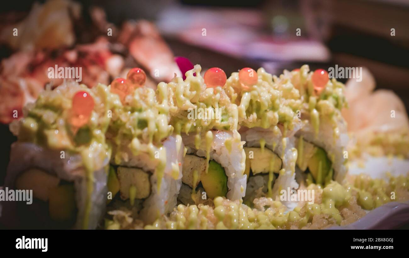 Close up Sushi rolls with cheese topping Stock Photo - Alamy