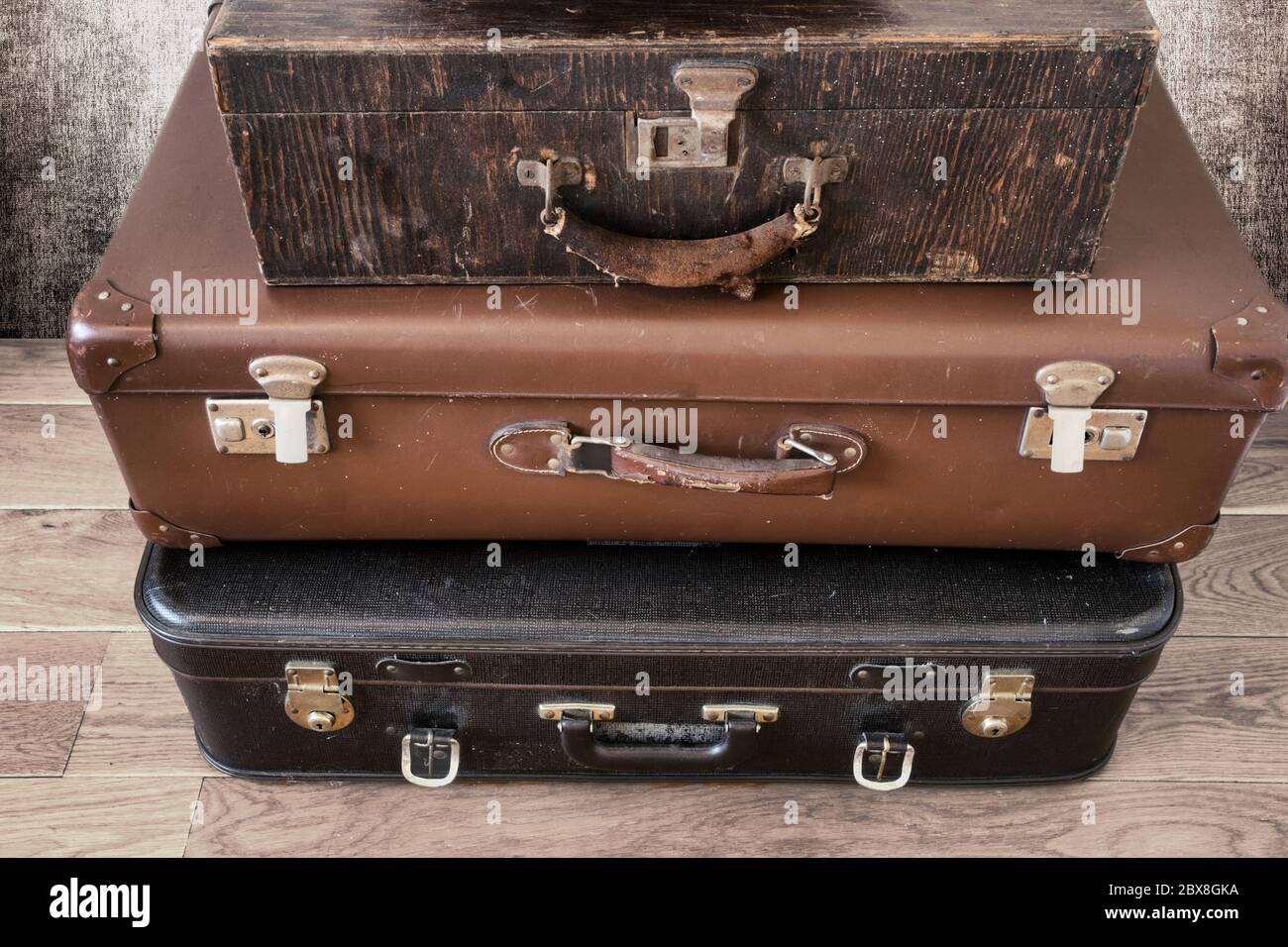 Old Vintage Suitcase in retro room on the floor, three piled suitcases ...
