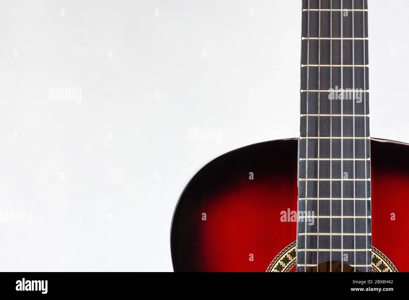 Acoustic guitar placed on the right side in landscape format on a light ...