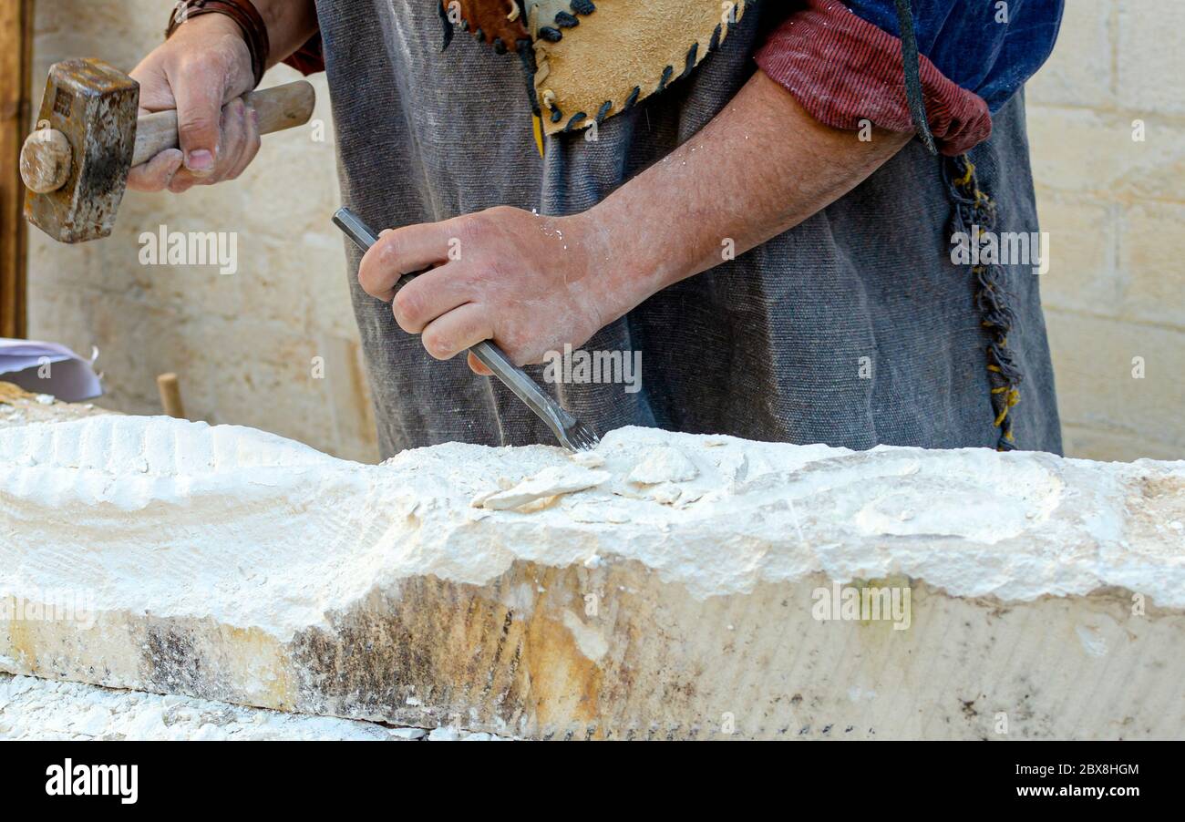 Stonemason With Ancient Costume During The Processing Of The Stone With ...