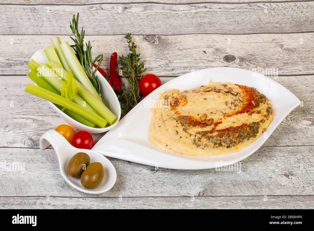 Vegan cuisine - Humus with celery sticks Stock Photo - Alamy