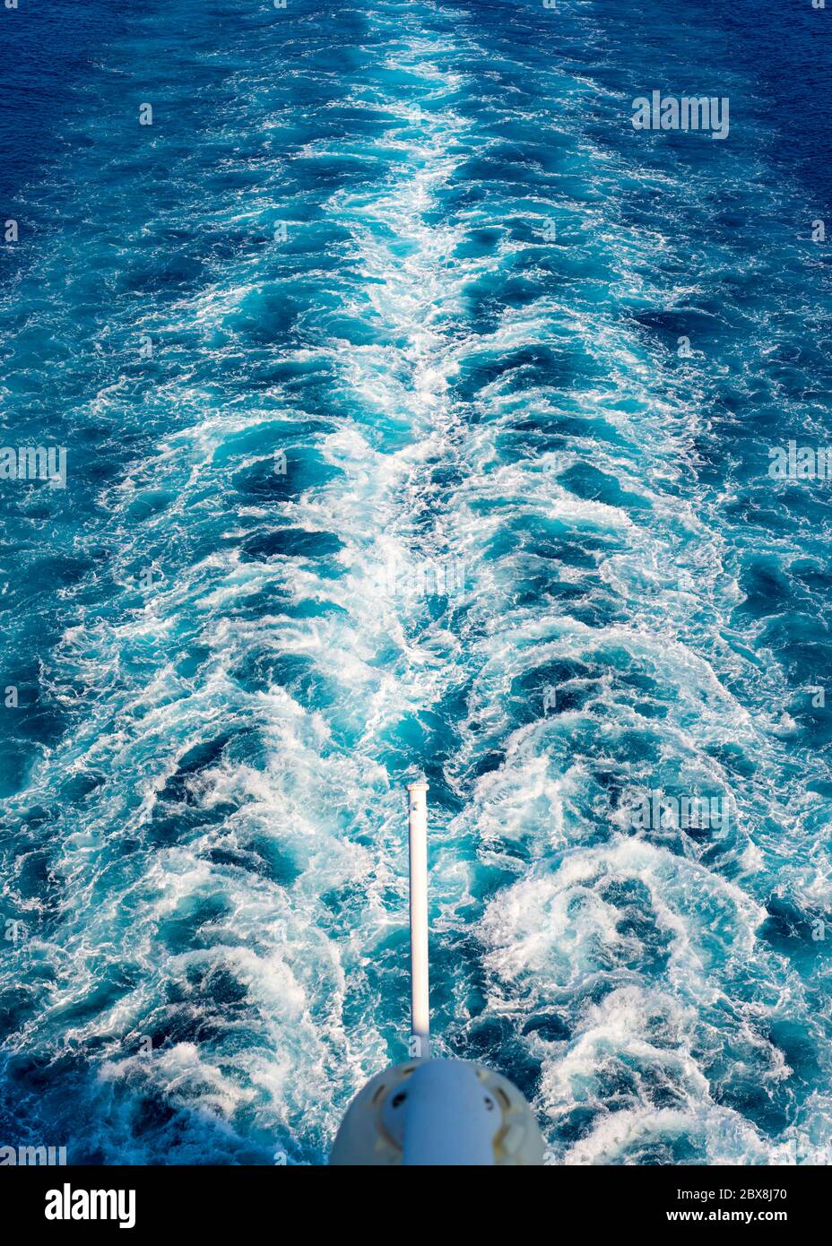 Trail on water surface behind of cruise ship Stock Photo - Alamy