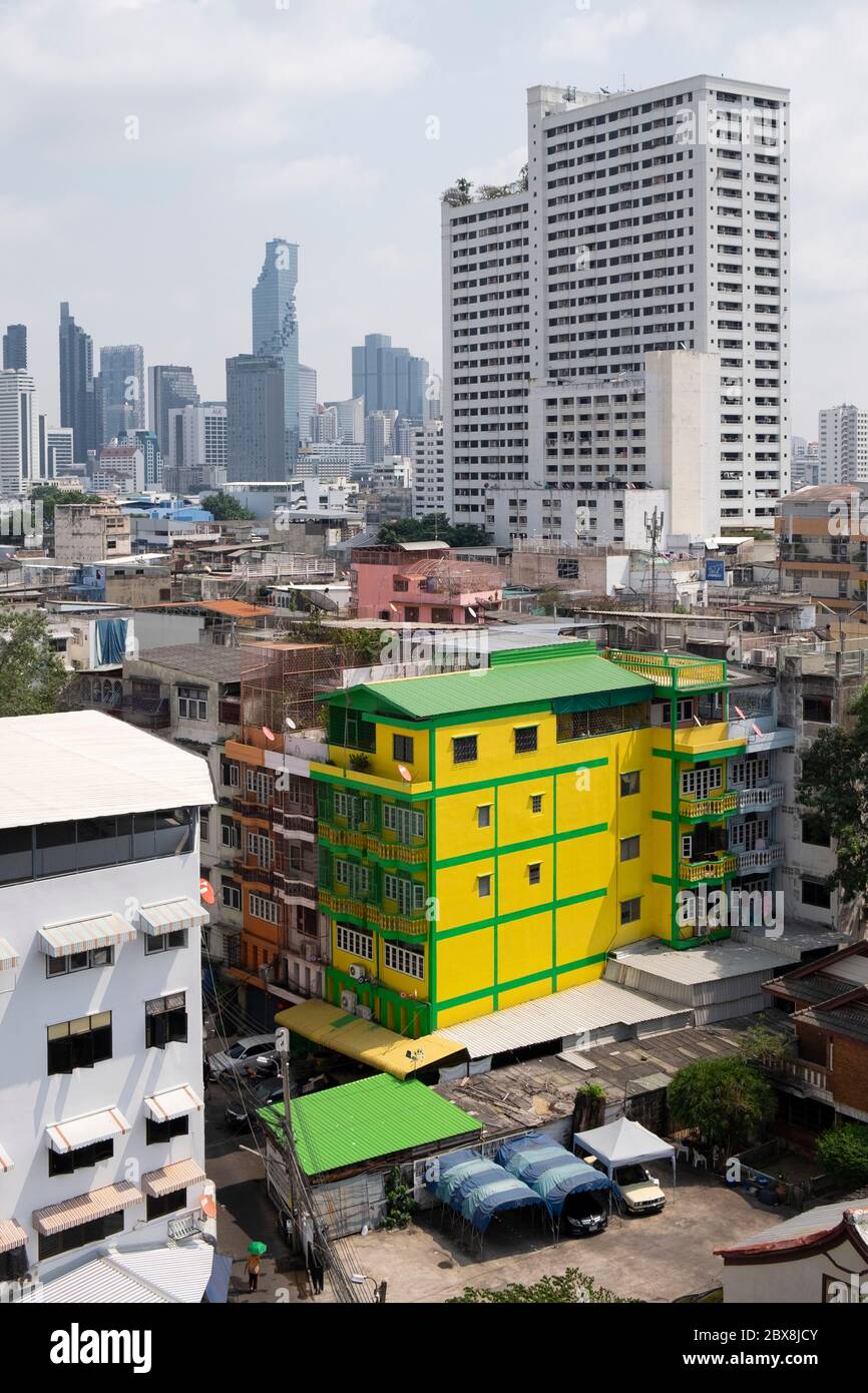 Yellow and green building and in the background the skyline of the ...