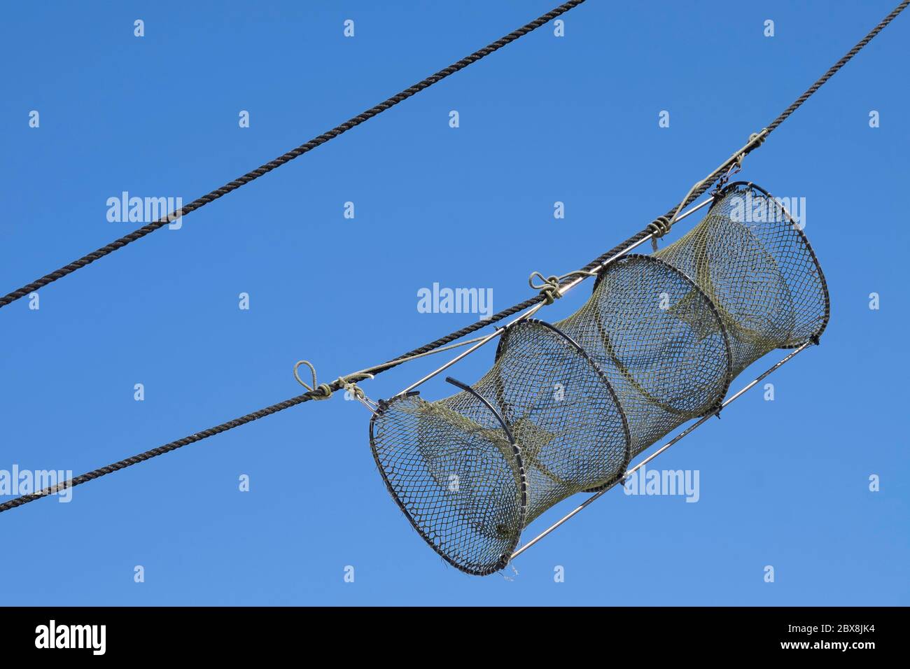 Fishing net - a fisherman's equipment hanging on the cables of a ...