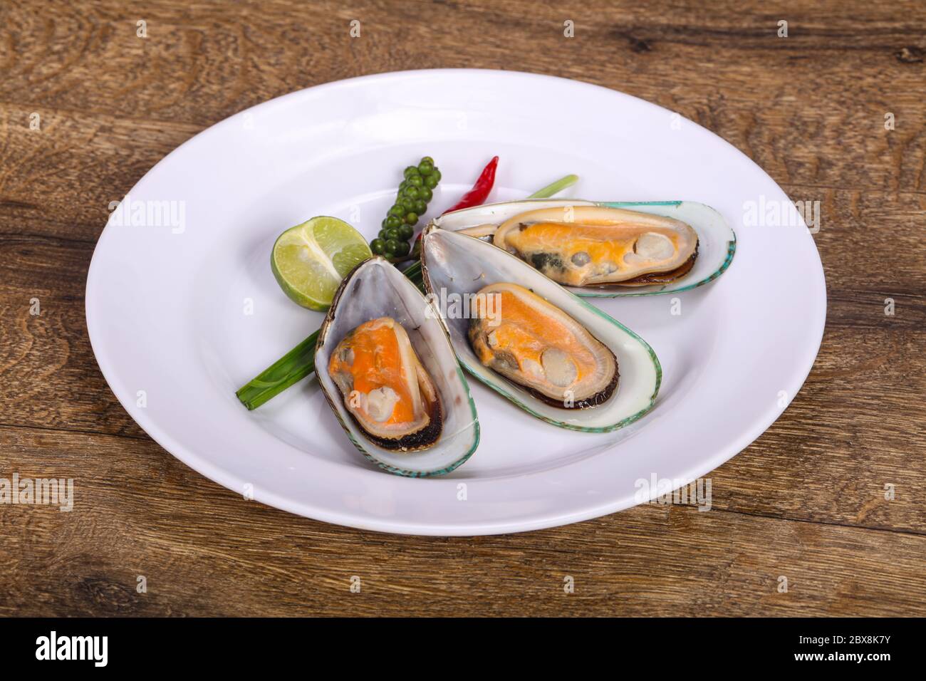 Half mussels with lime and green pepper Stock Photo - Alamy