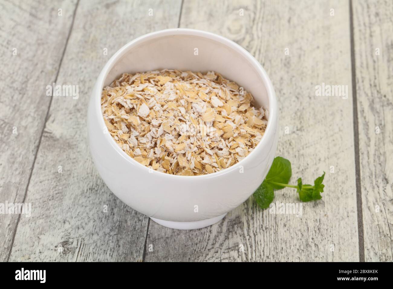 Raw oats in the bowl for breakfast Stock Photo - Alamy