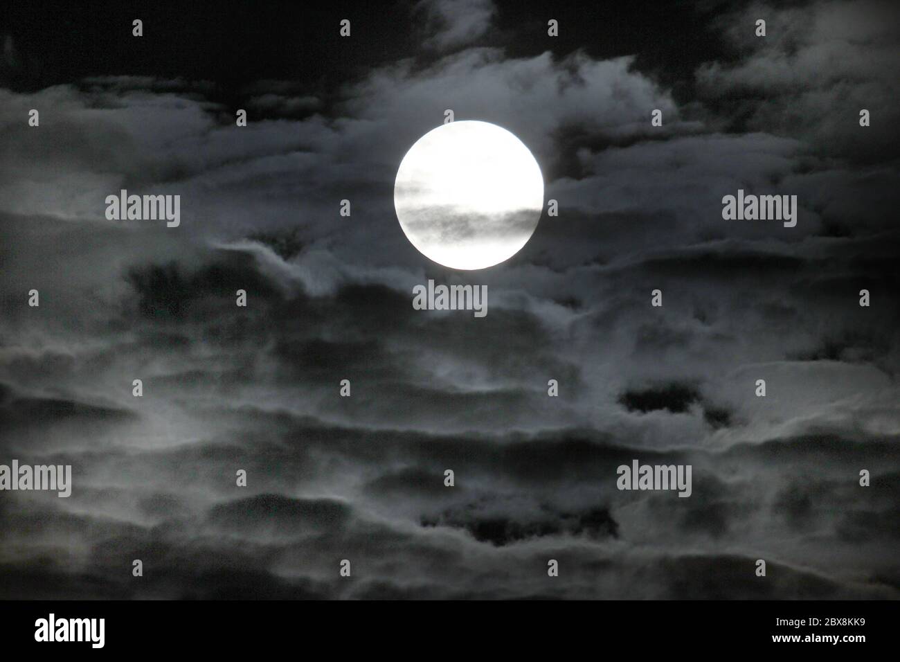 Full moon behind some clouds. Moon of the night of the penumbral lunar eclipse 5.06.20 Germany ...