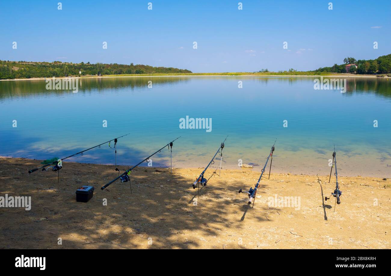 Fishing rods on the lake beach Stock Photo - Alamy