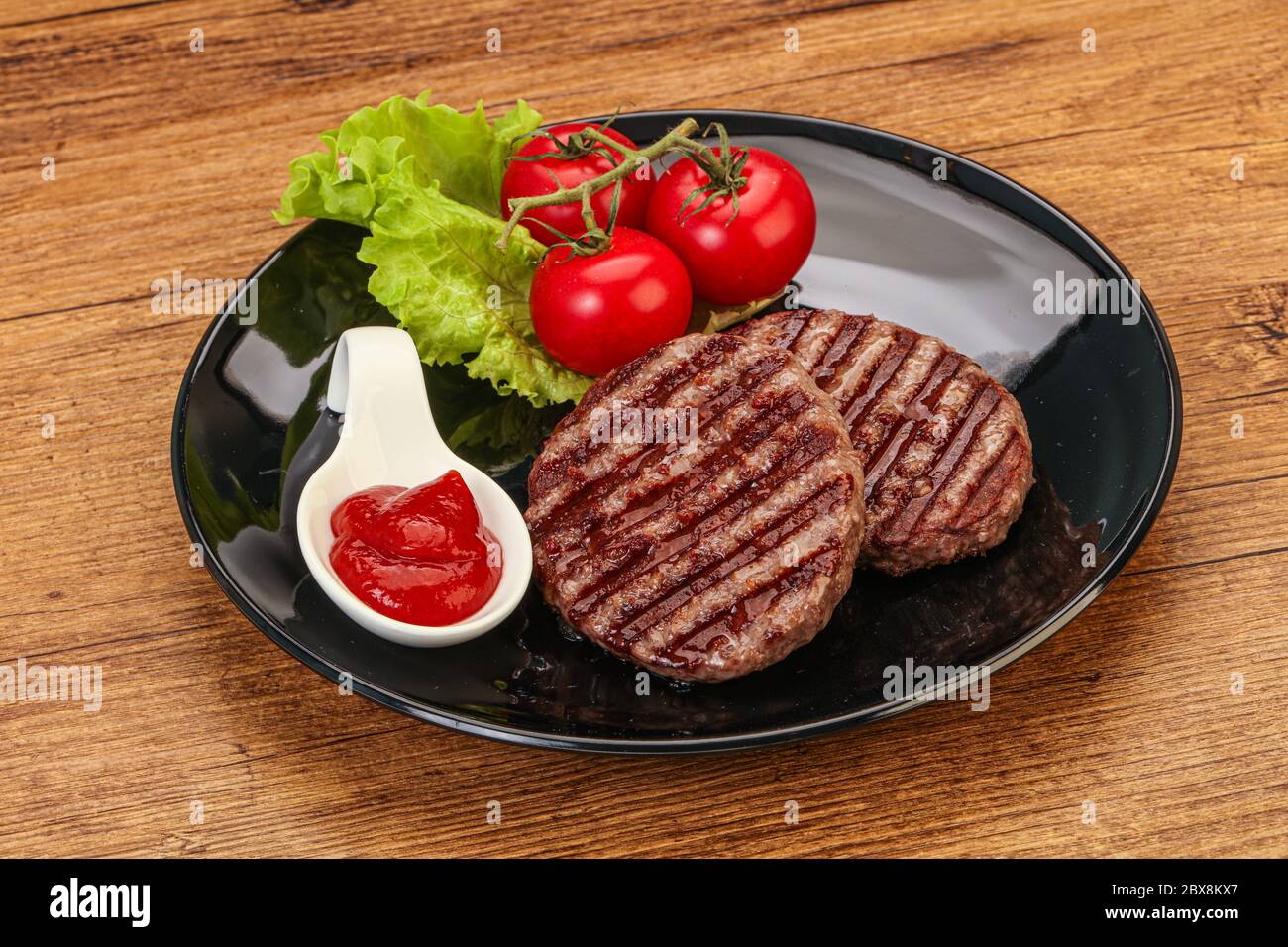 Grilled burger cutlet with tomato sauce Stock Photo - Alamy