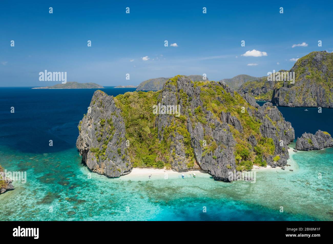 Aerial panoramic view of a tiny tropical island with beach, coral reef ...