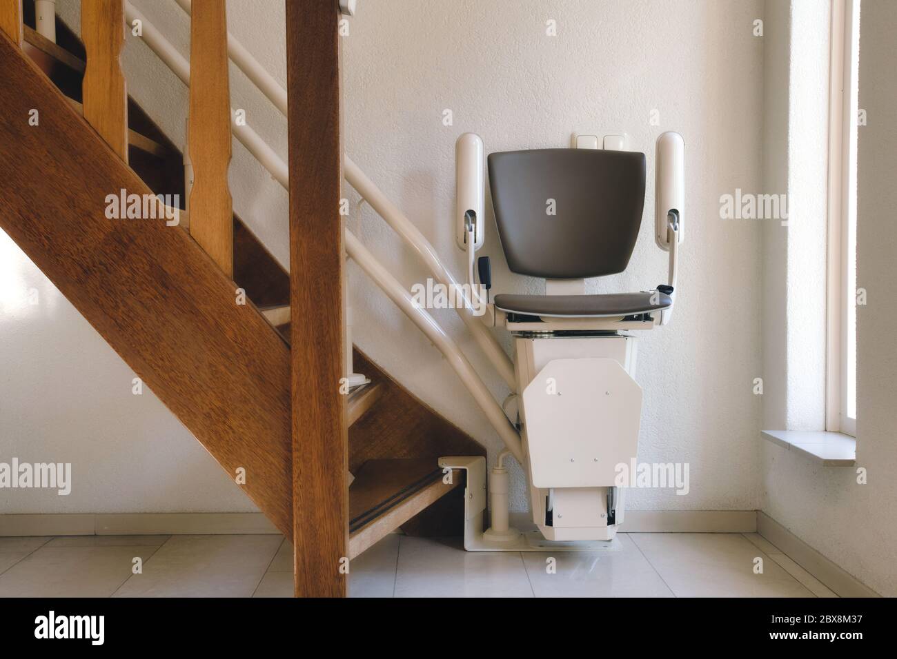 Automatic stairlift on staircase for elderly or disability in a house ...