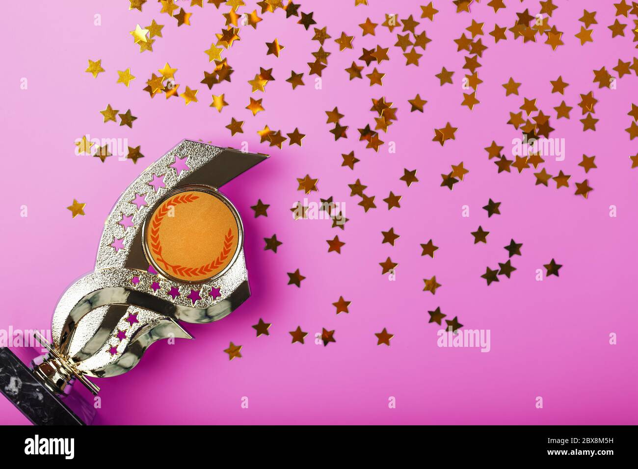 Superprize of gold with fireworks of stars on a pink background Stock ...