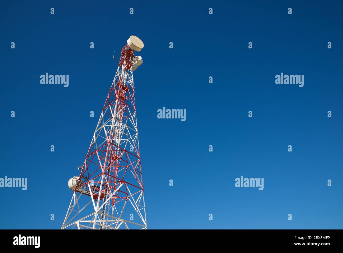 Telecommunications tower with clear blue sky Stock Photo - Alamy