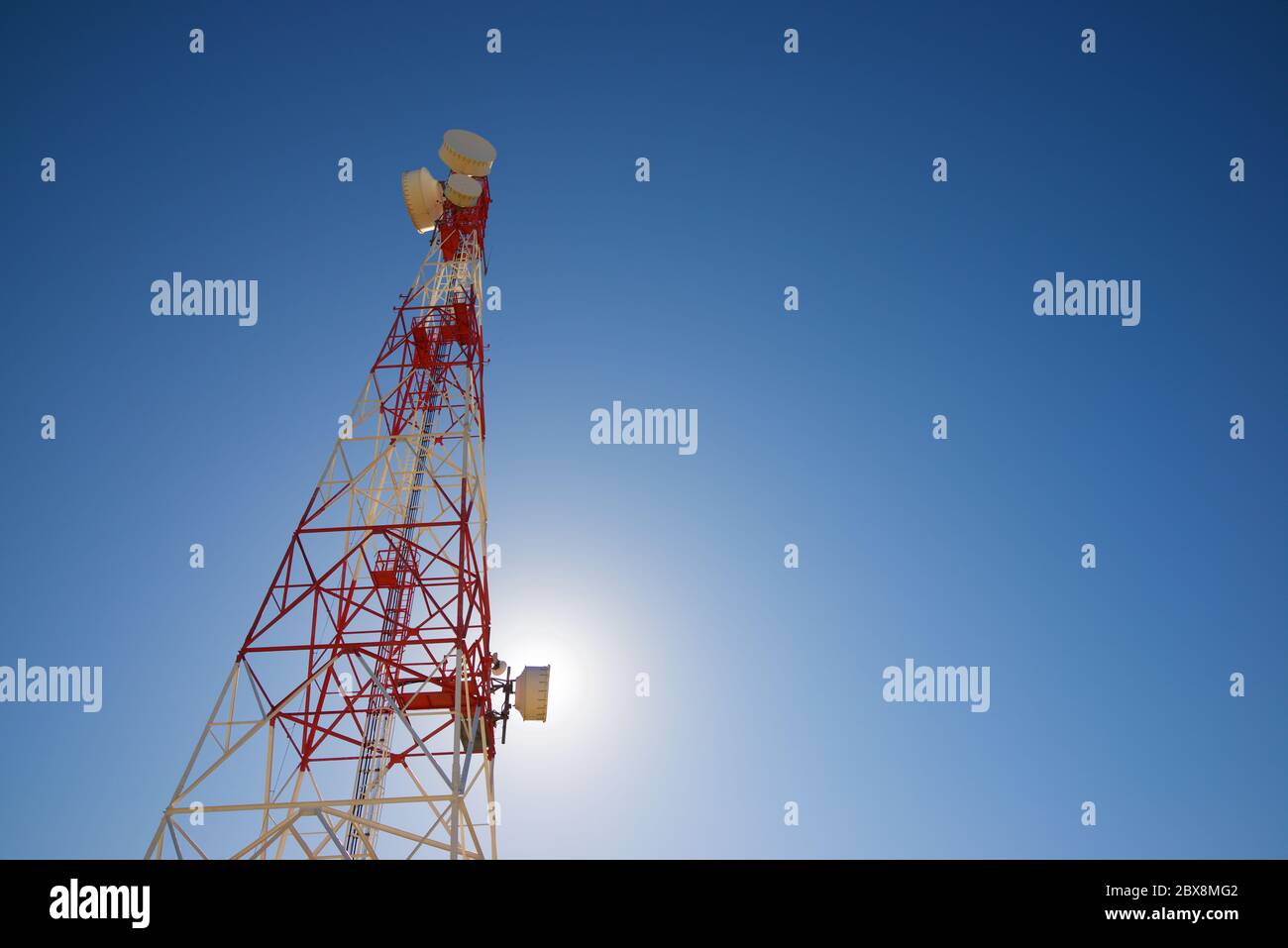 Telecommunications tower with clear blue sky Stock Photo - Alamy