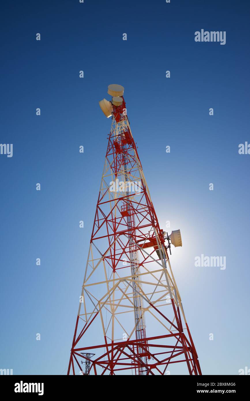 Telecommunications tower with clear blue sky Stock Photo - Alamy