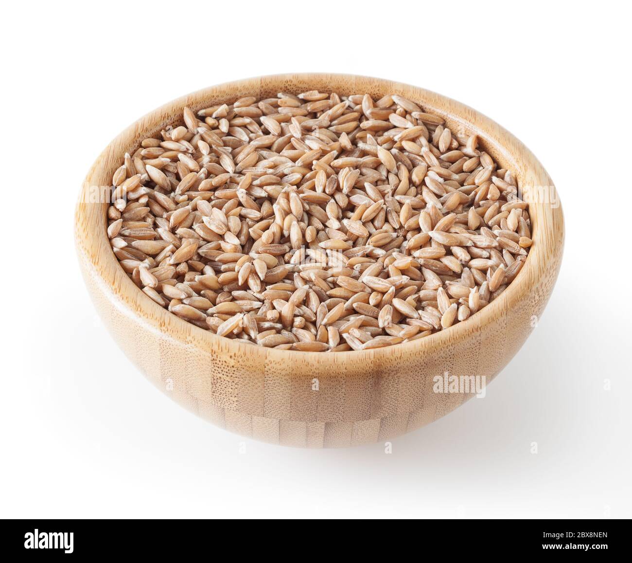Grains of spelt in wooden bowl isolated on white background wiht ...