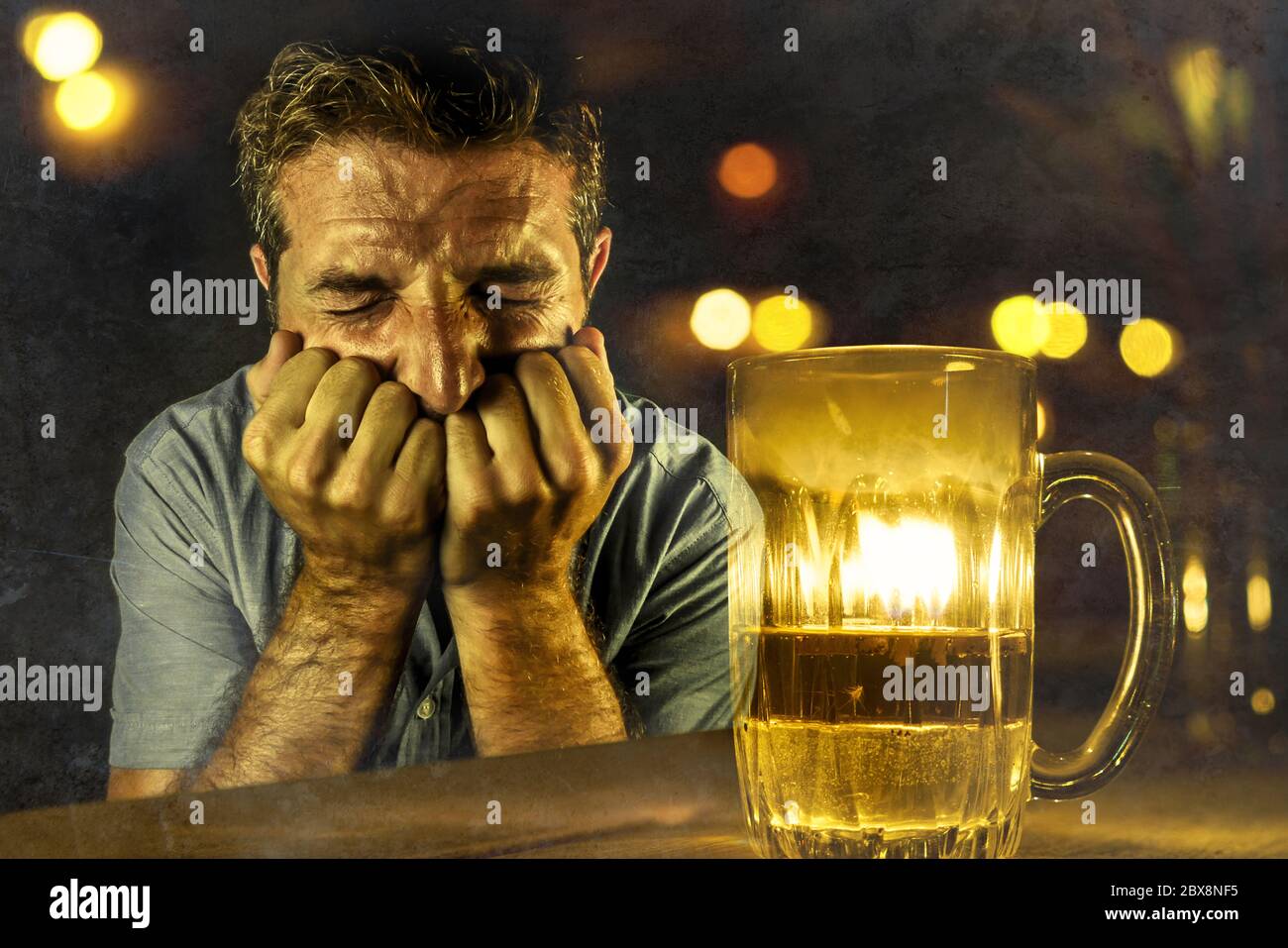 young desperate and depressed alcoholic man drinking beer wasted and ...