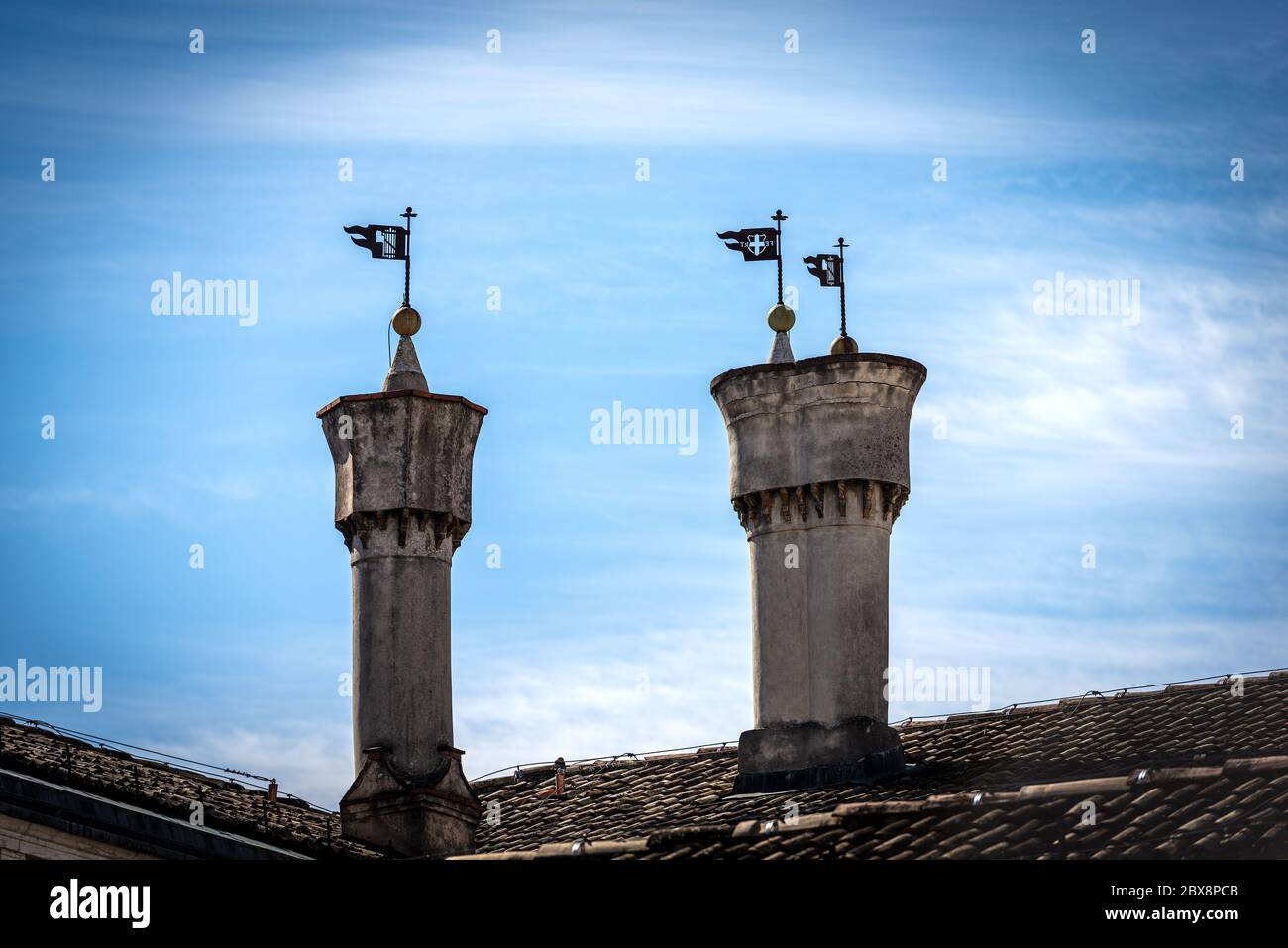 Two ancient chimneys in Venetian style on the roof of the Castello del ...