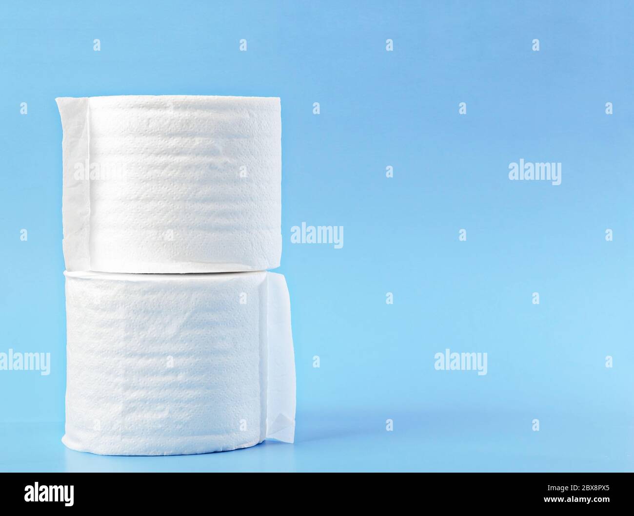 Tissue paper rolls on the blue background Stock Photo - Alamy