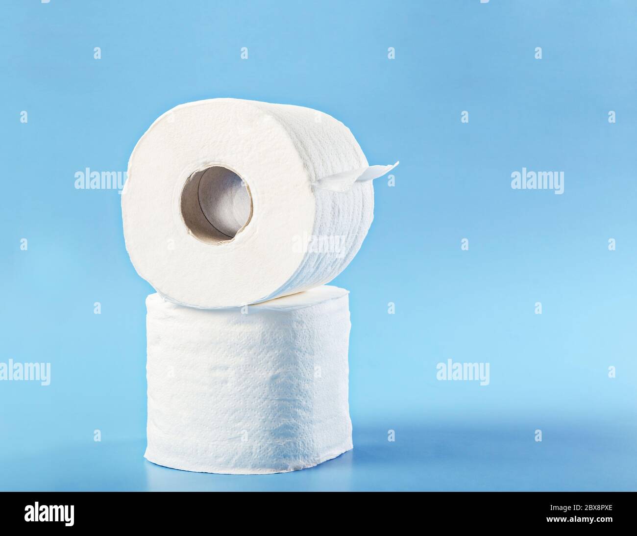 Tissue paper rolls on blue background Stock Photo - Alamy