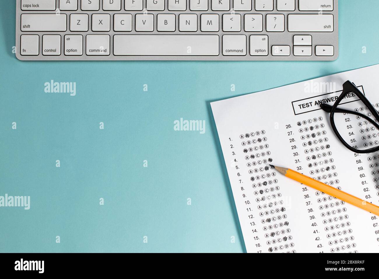 Take the exam, write the exam. Exam paper on blue background, top view ...