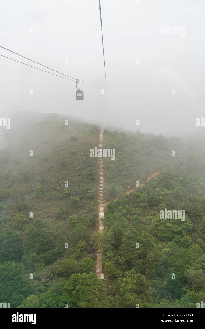 View of the Ngong Ping 360 cable cars going into the cloud, Lantau ...