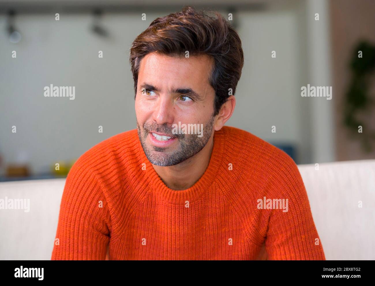 lifestyle home portrait of young attractive and happy 30s man smiling ...