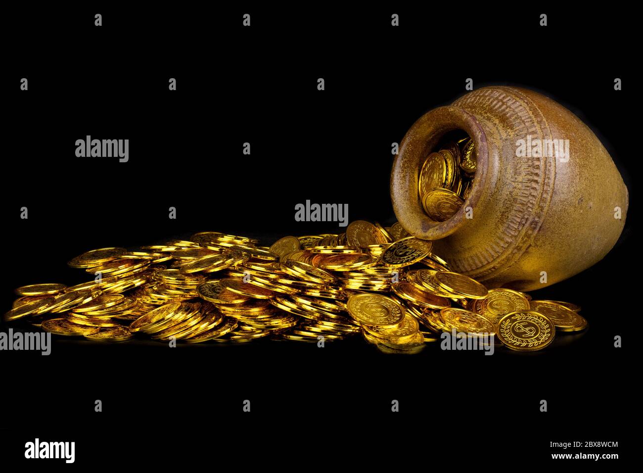 Gold coin in treasure old pot on black background Stock Photo - Alamy
