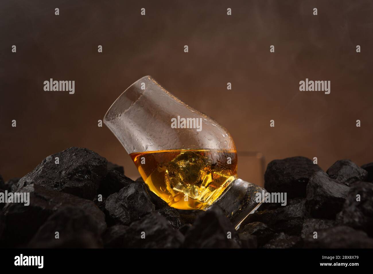 Whisky in a Glencairn Whisky Glass sitting on burning coal, whisky ...