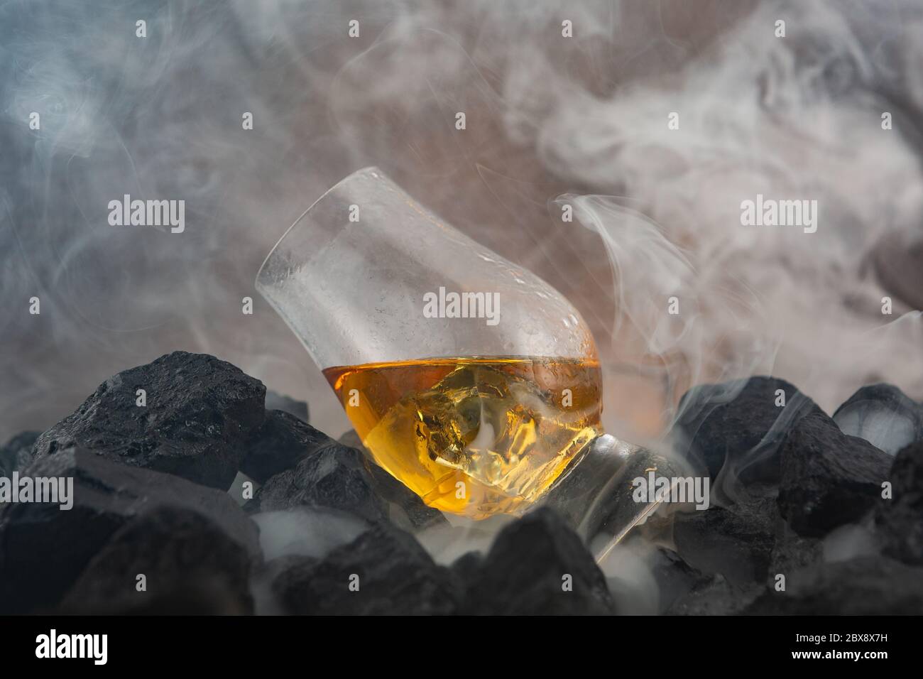Whisky in a Glencairn Whisky Glass sitting on burning coal, whisky ...